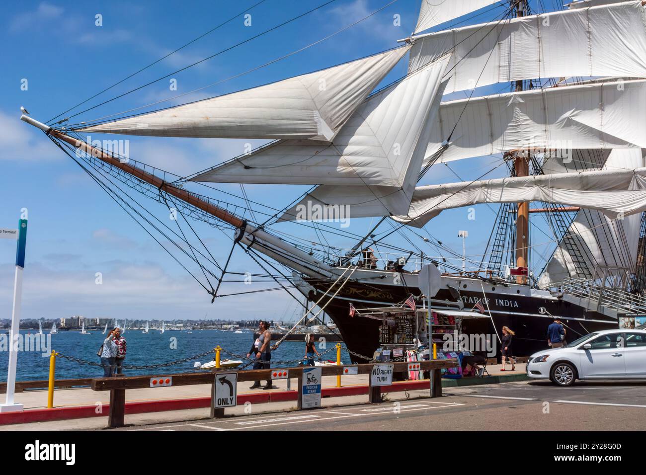 Tourists and locals pass the historic sailing ship Star of India moored ...