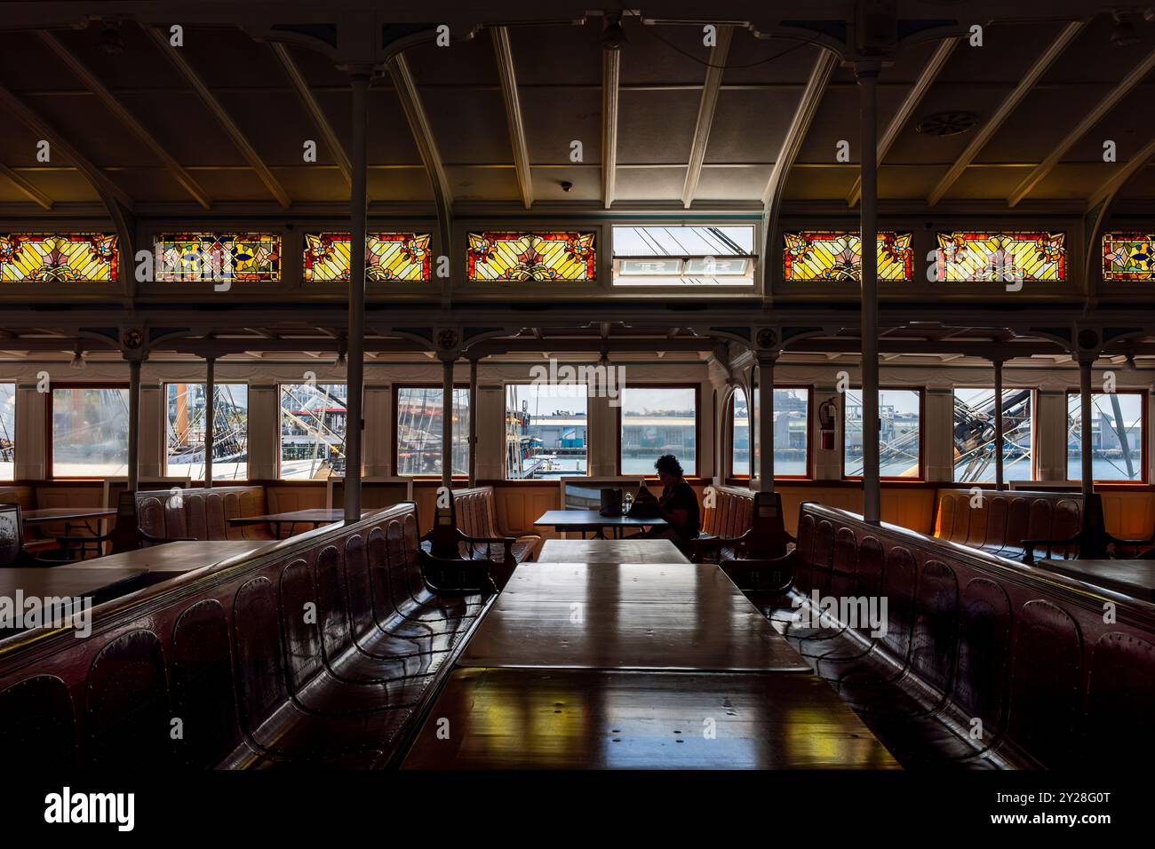A lone figure seated aboard the historic San Francisco Bay steam ferry ...