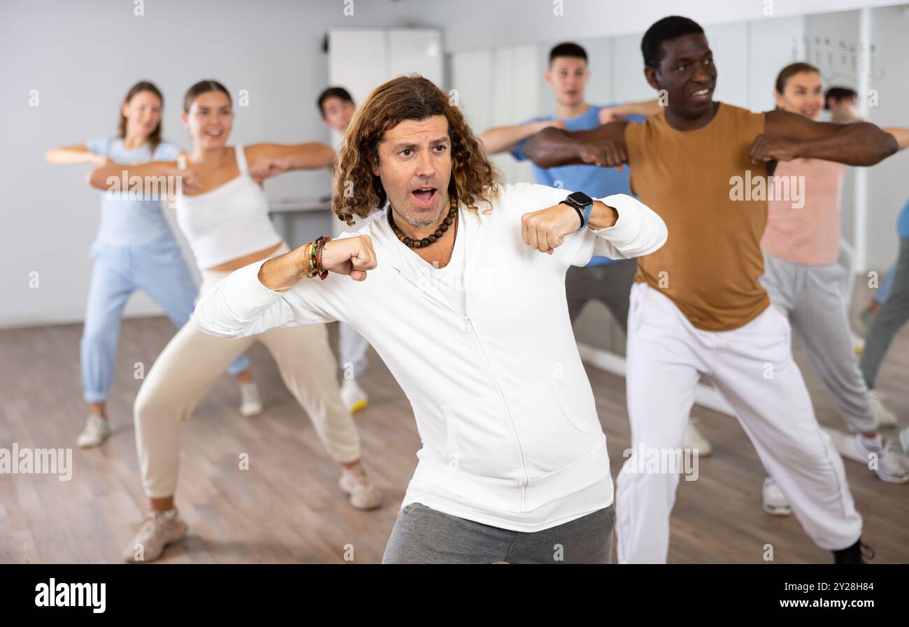 Group of different people rehearsing dance in dance studio Stock Photo ...