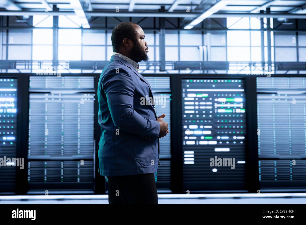 Engineer walking in data center, monitoring system performance, identifying bottlenecks and ...