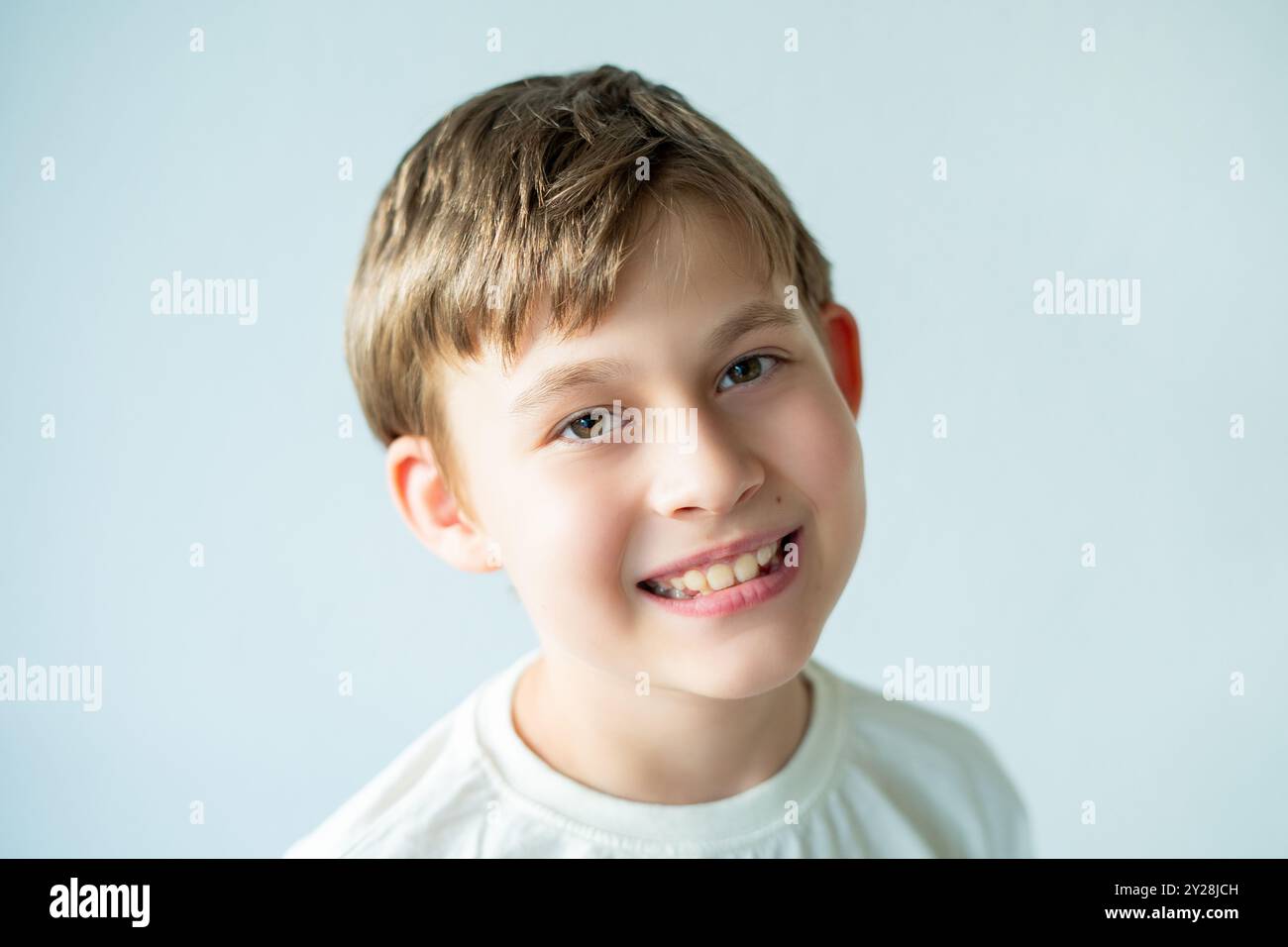 Portrait of 10 year old boy who smiles and shows the fallen cliques ...