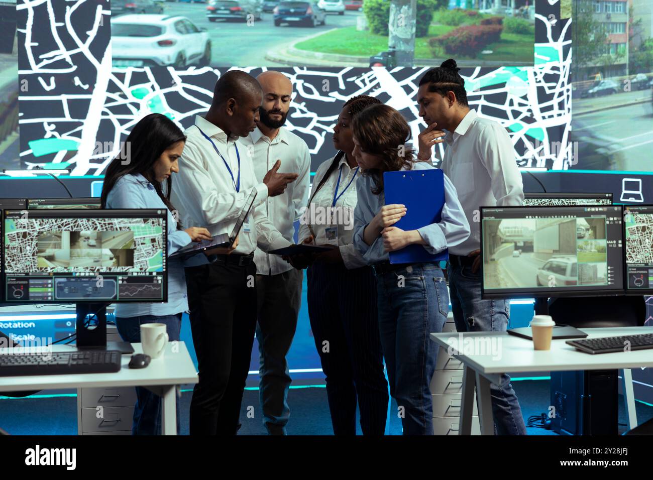 Group of agency employees sharing insight on cargo logistics and gps ...