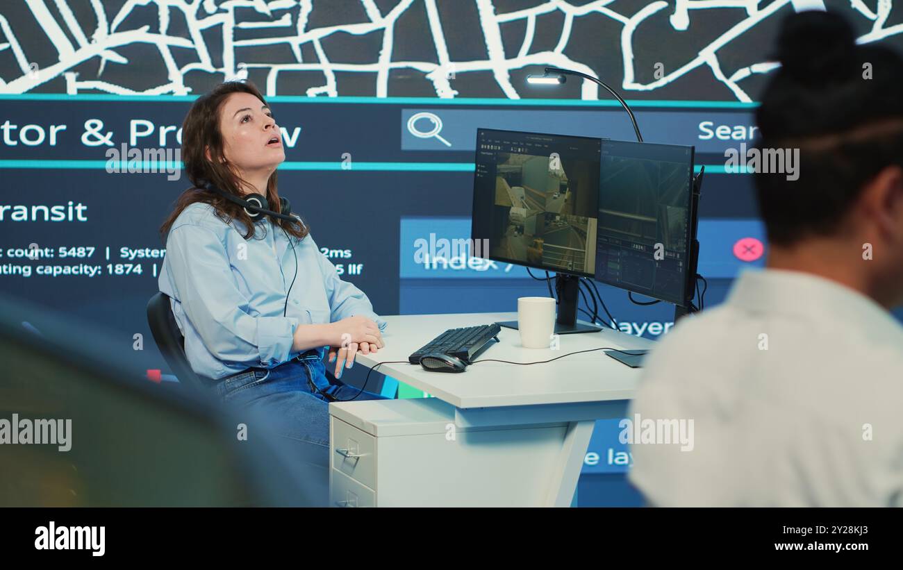 Young stressed call center operator communicating gps coordinates to ...