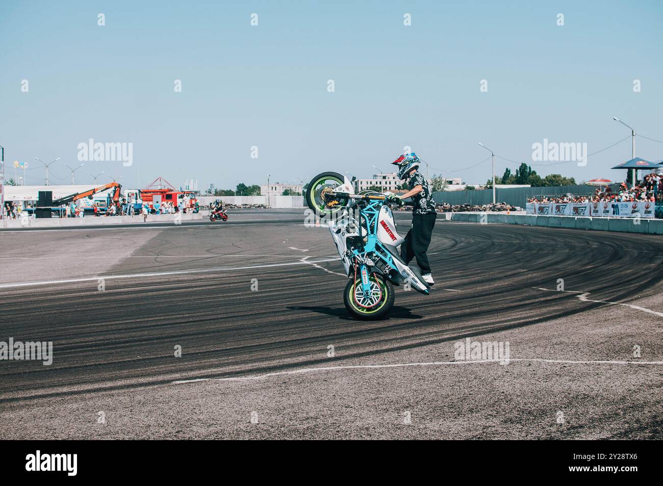 Biker in a black uniform driving a red sports motorcycle on a curvy ...
