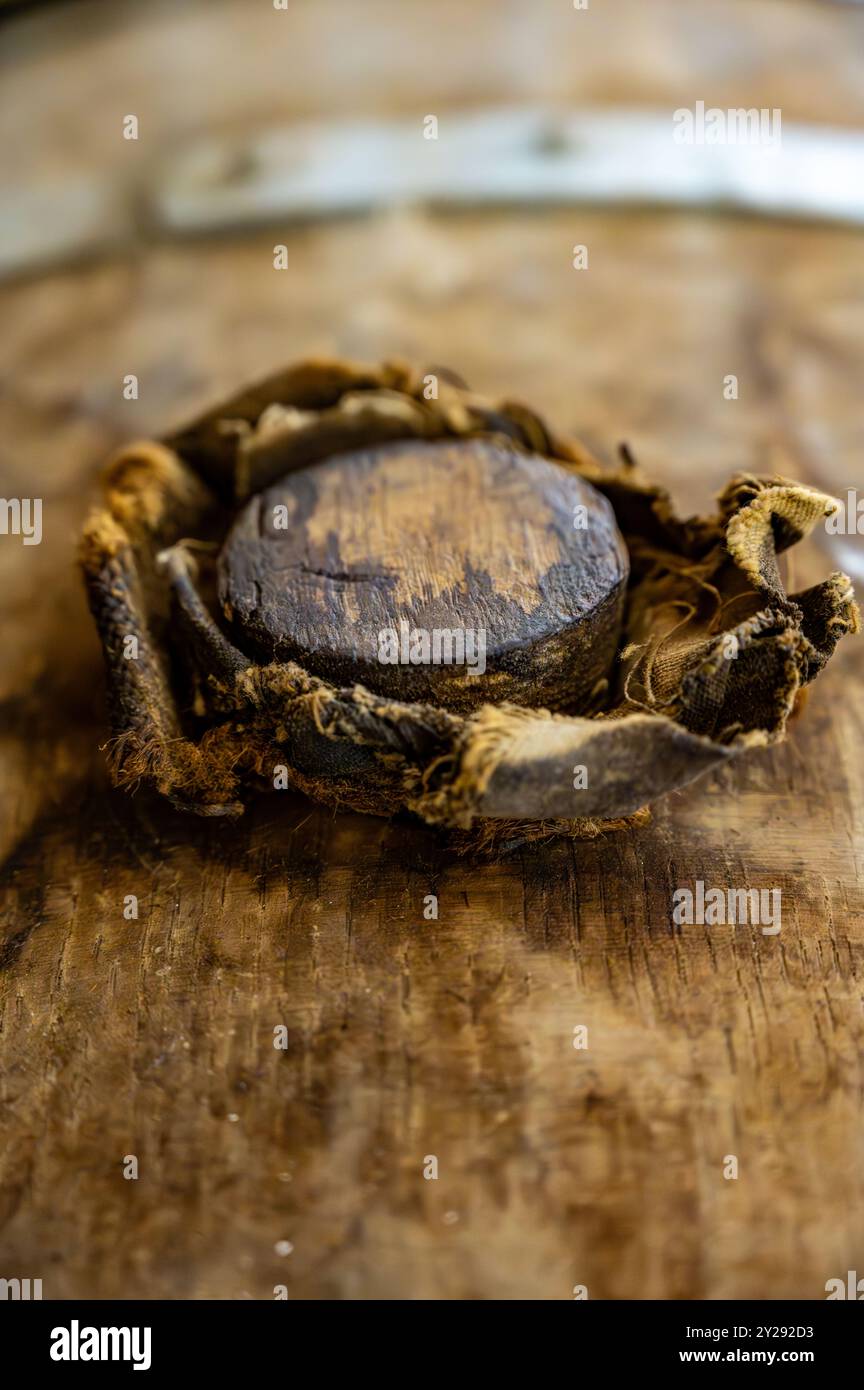 Aging process of cognac spirit in old dark French oak barrels in cool ...