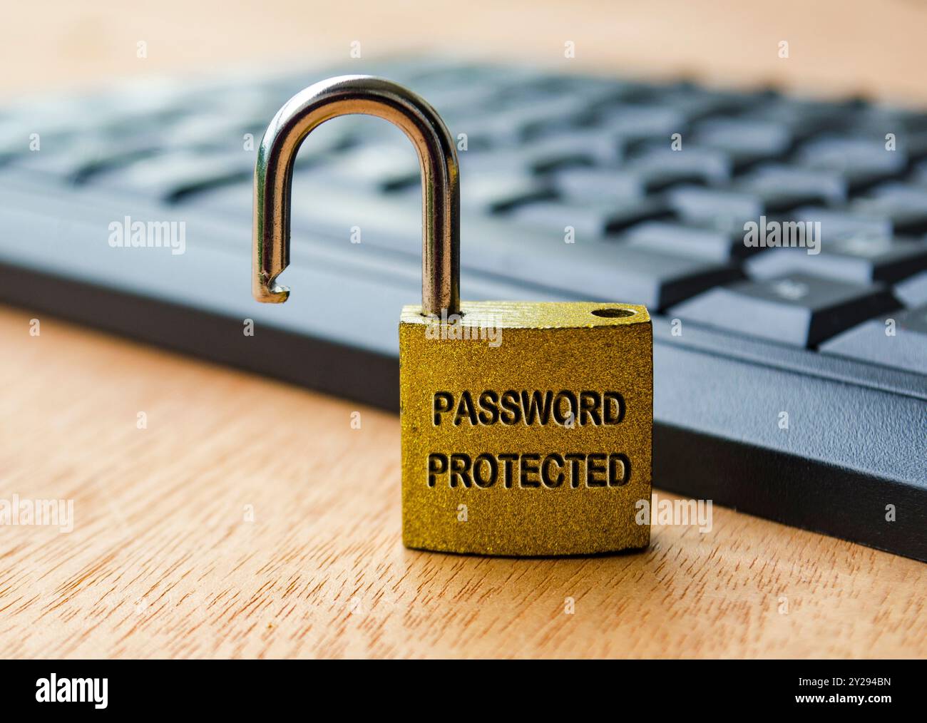 Password protected text engraved on padlock with laptop keyboard background. Password security ...