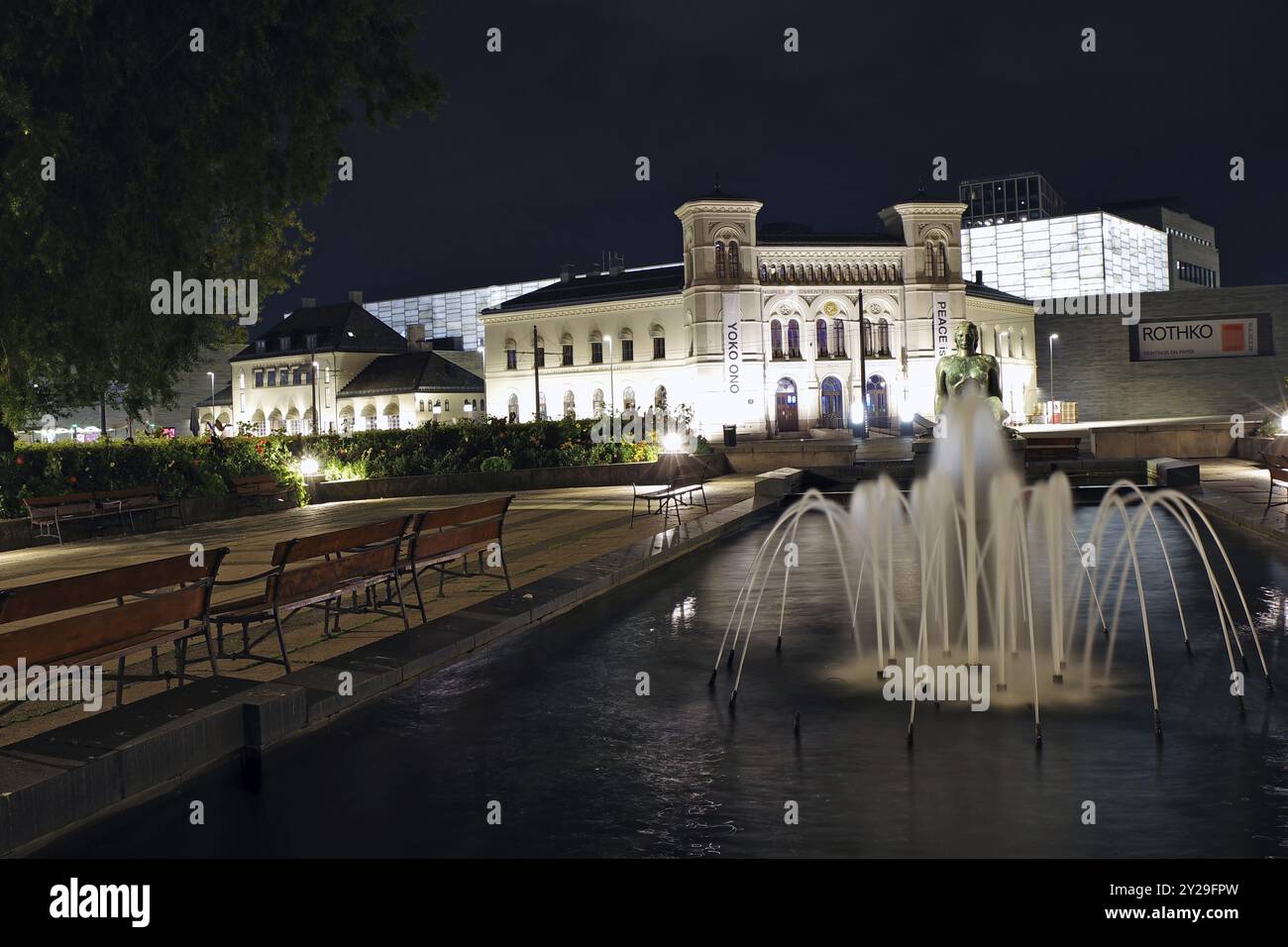 Historic building at night with illuminated fountain and benches in the ...