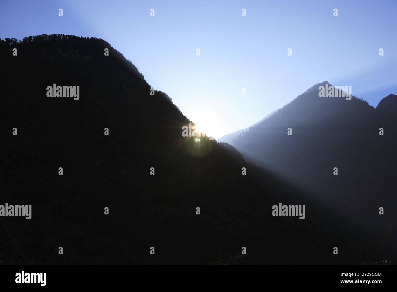 Shafts of sunlight behind clouds Stock Photo - Alamy