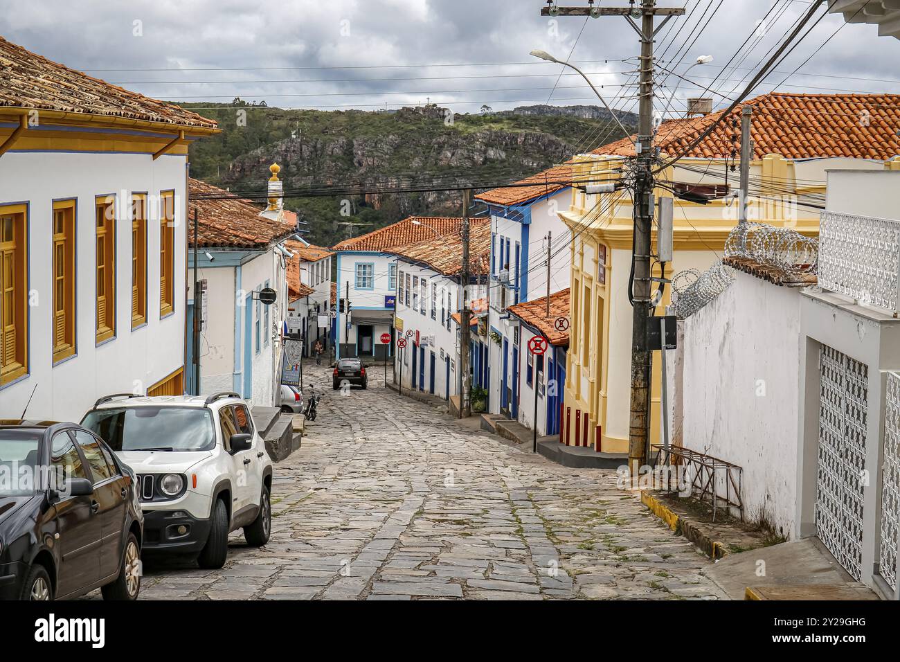 Typical cobblestone street with traditional houses in historic center ...