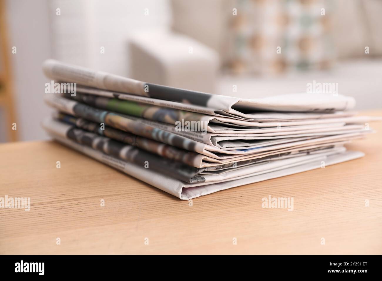 Stack of newspapers in different languages on table indoors Stock Photo ...