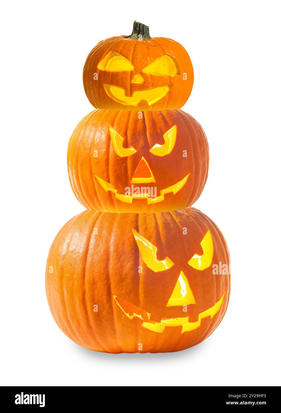 Stack of pumpkins with carved spooky faces on white background ...