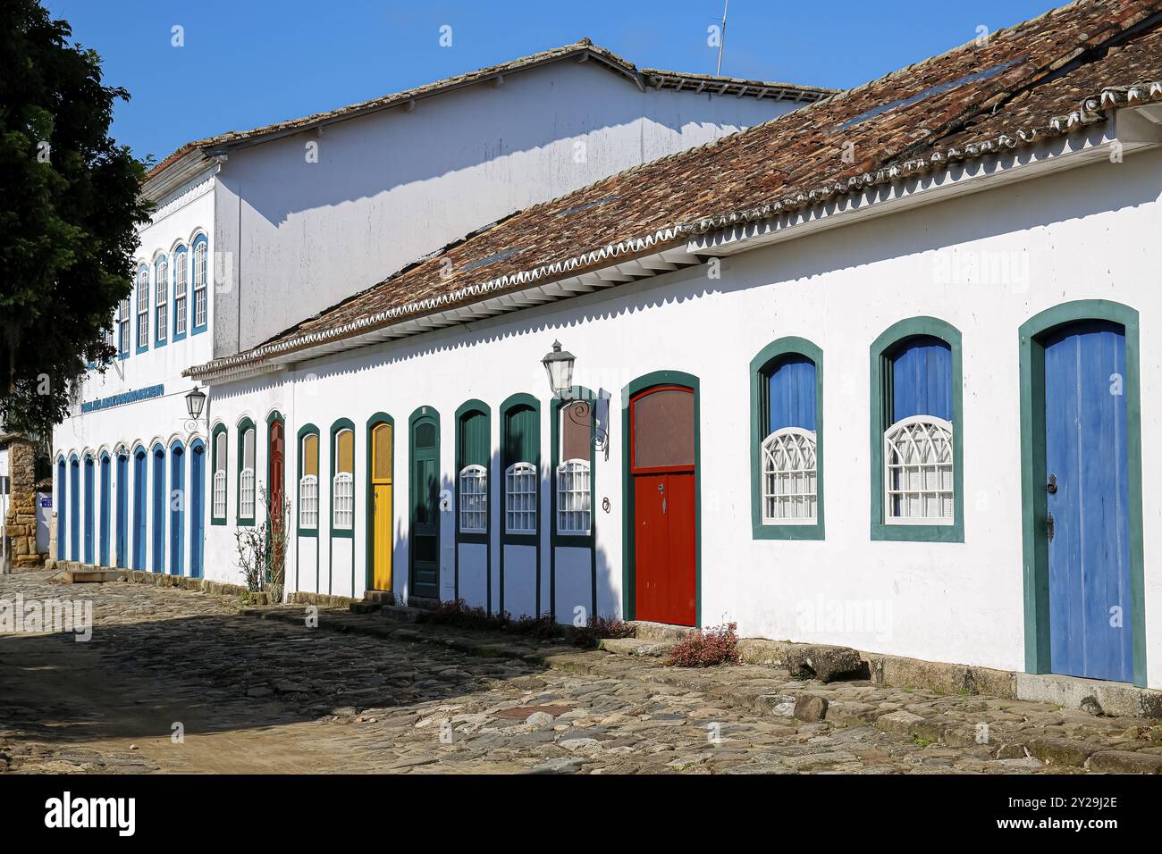 Typical house facades with colorful doors and windows on sunny day in ...