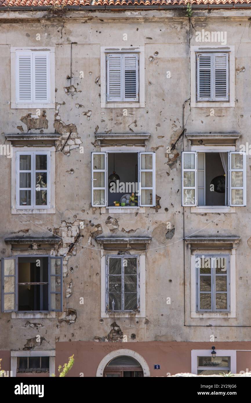 Window of an old building with bullet holes from the Balkan War. Window ...