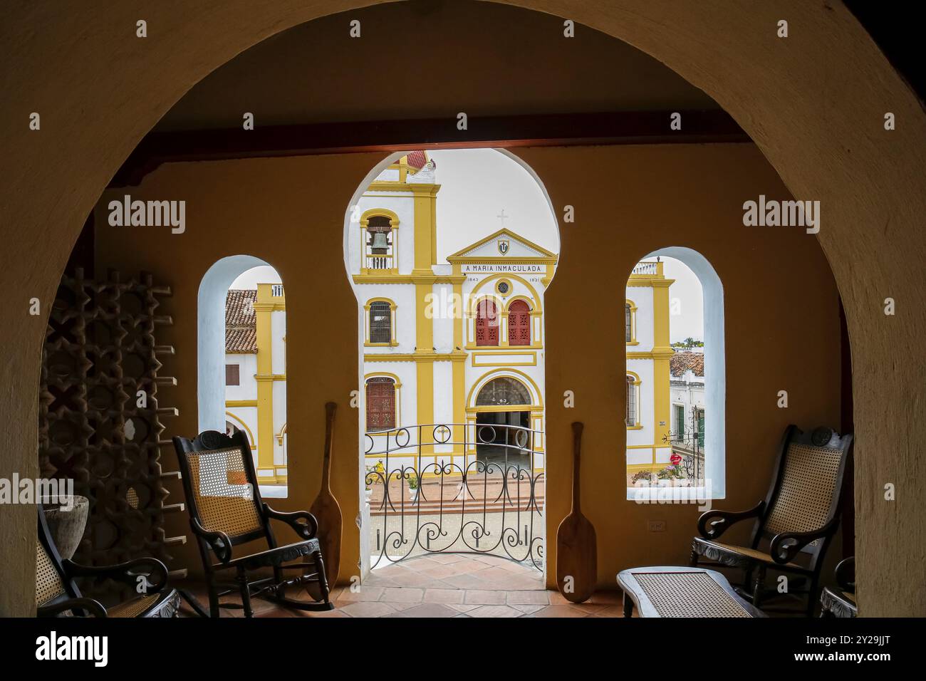 View from a room with open door and windows to a colonial church in ...