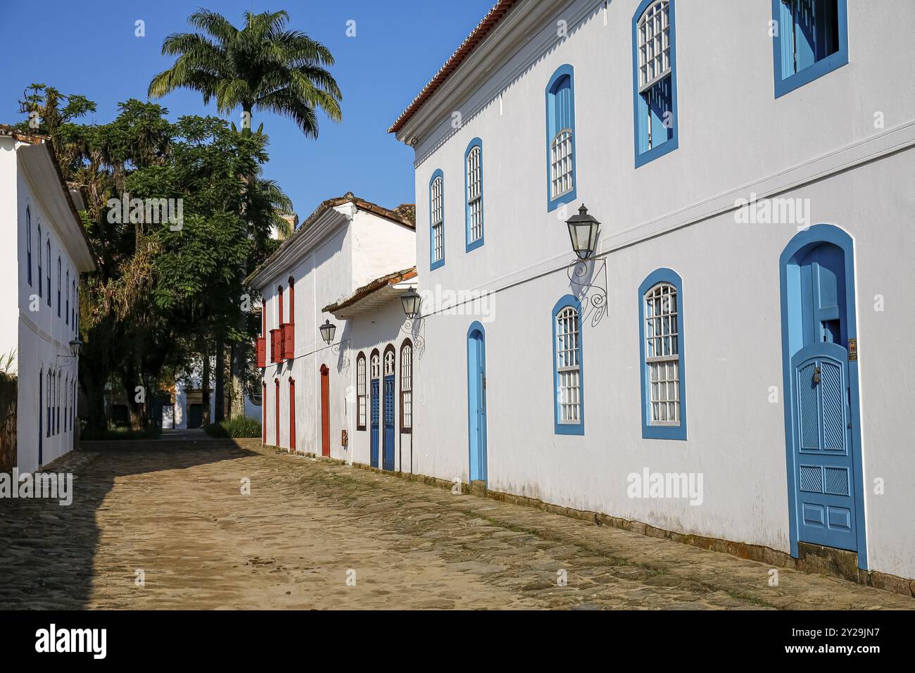 Typical cobblestone street covered with mud from high tide with ...
