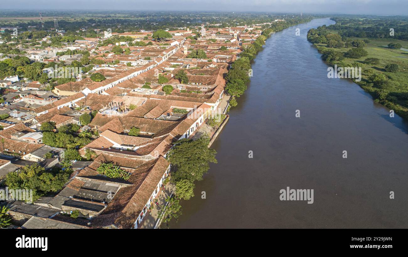 Aerial view of the historic town Santa Cruz de Mompox in sunlight with river and green ...