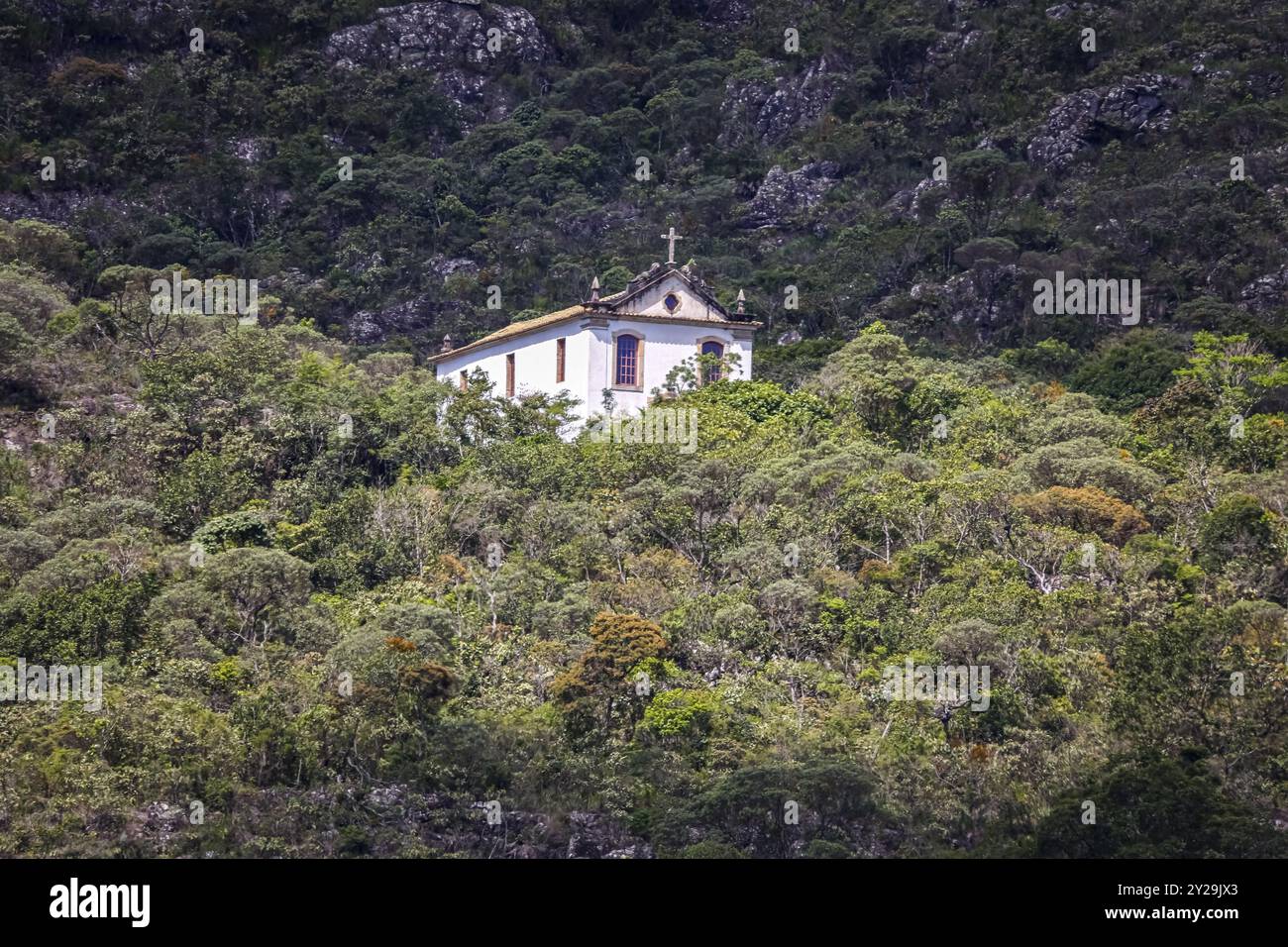Small historic chapel in sunlight surrounded by Atlantic forest an ...