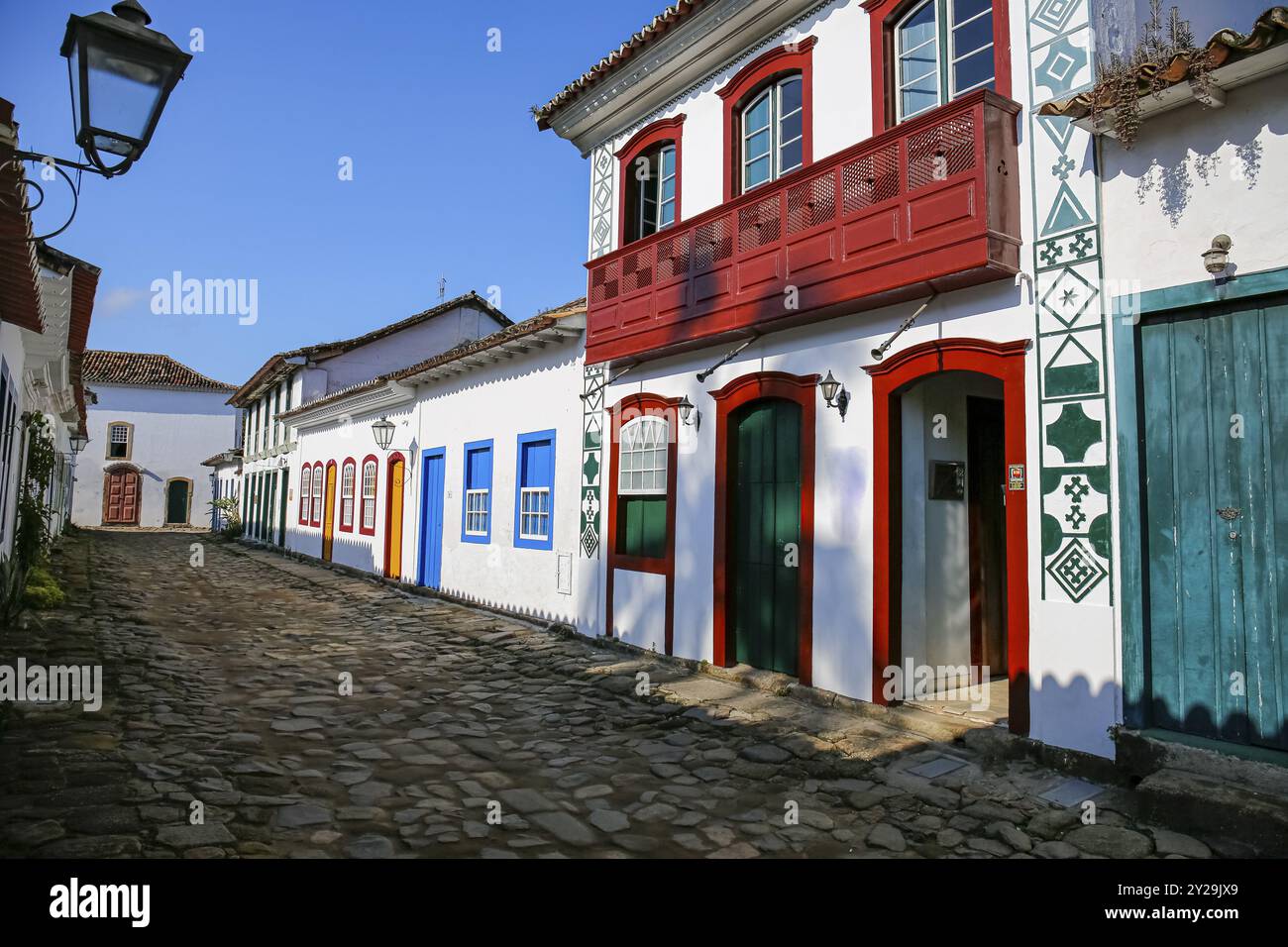 Typical cobblestone street with decorative and colorful colonial ...