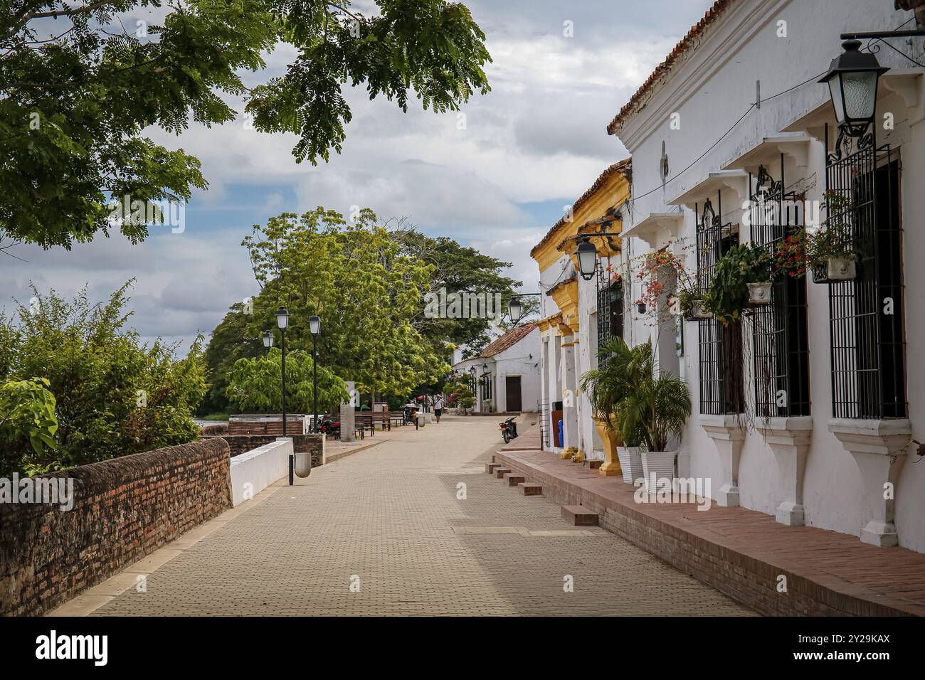 Typical street with historic white buildings, colorful pillars and ...