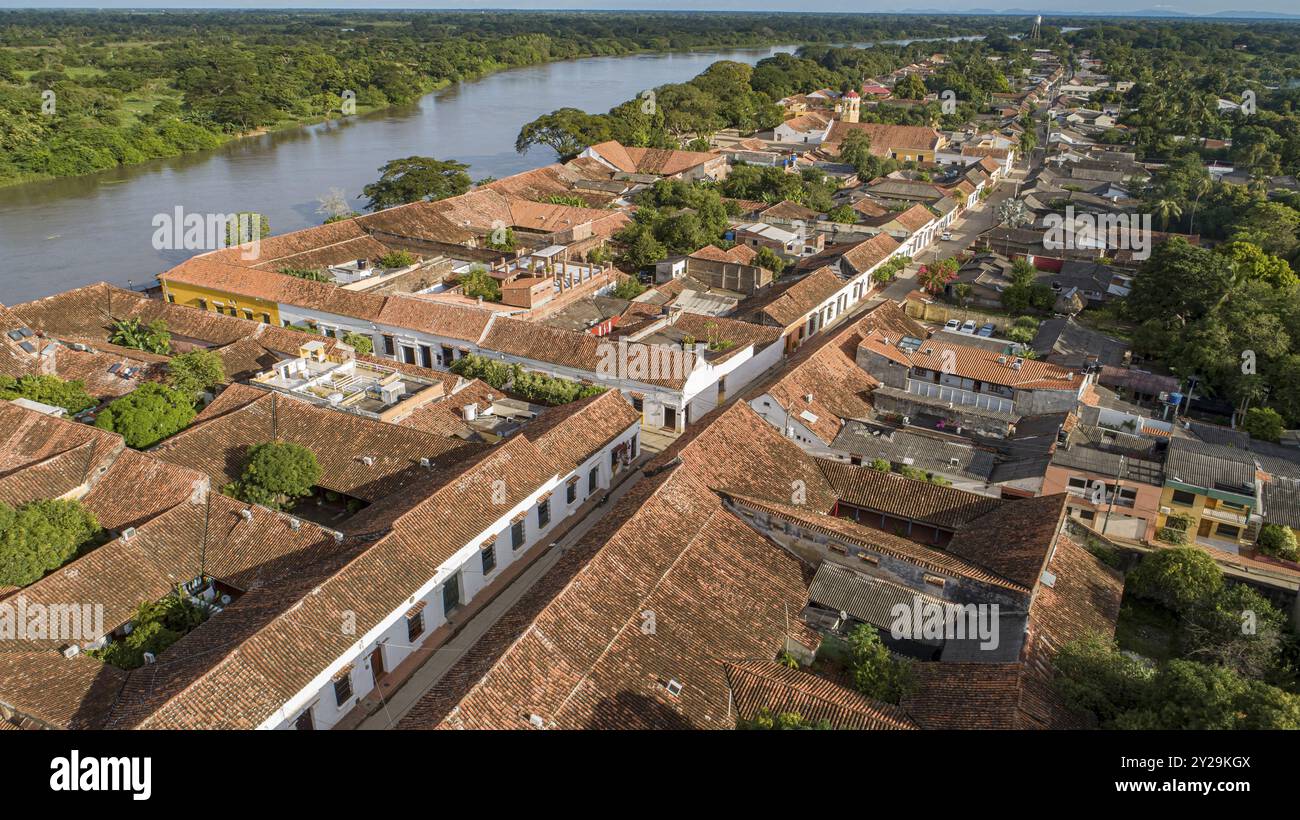 Aerial view of the historic town Santa Cruz de Mompox in sunlight with river and green ...