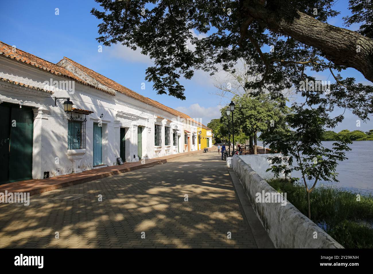 River promenade with typical historic houses, trees and river, Santa ...