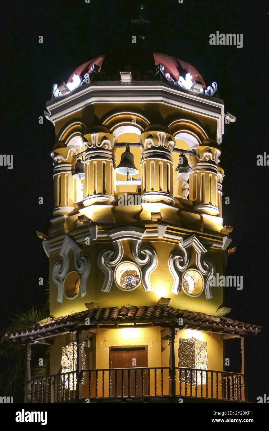 Close-up of illuminated clock tower of church of Saint Barbara at night ...