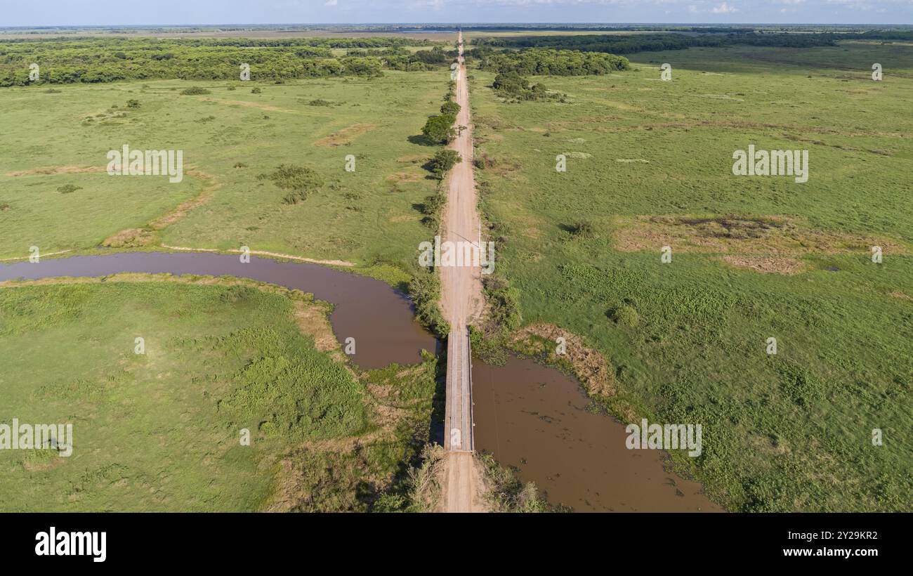 Aerial view of Transpantaneira dirt road crossing a river by a wooden ...