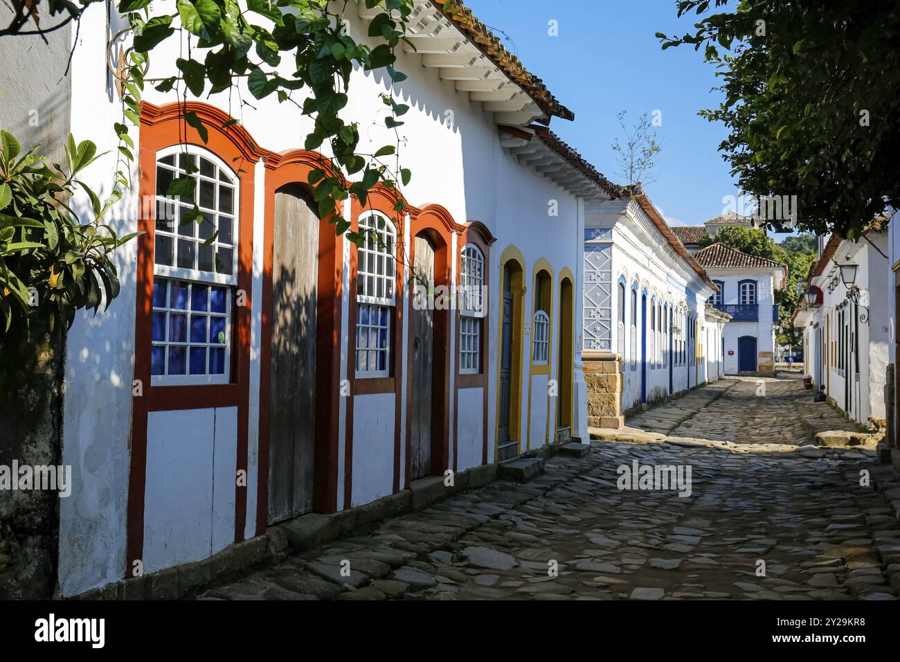 Typical cobblestone street with colorful colonial buildings in the late ...