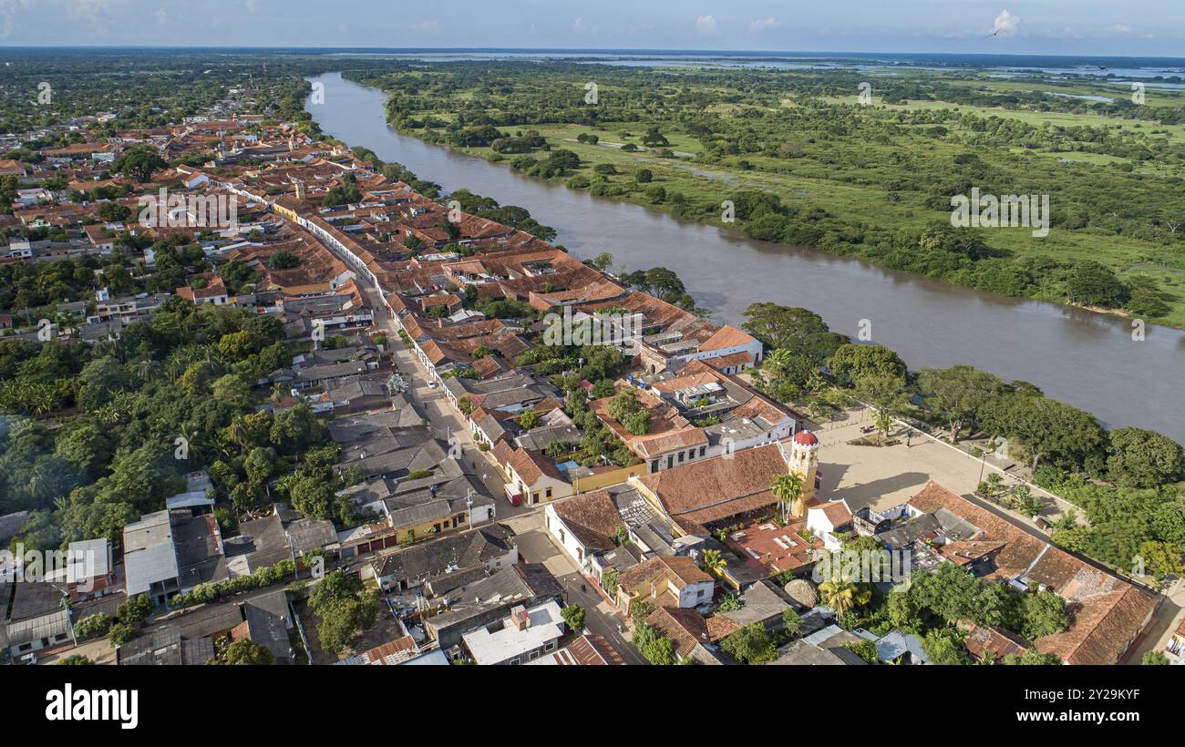 Aerial view of the historic town Santa Cruz de Mompox in sunlight with river and green ...