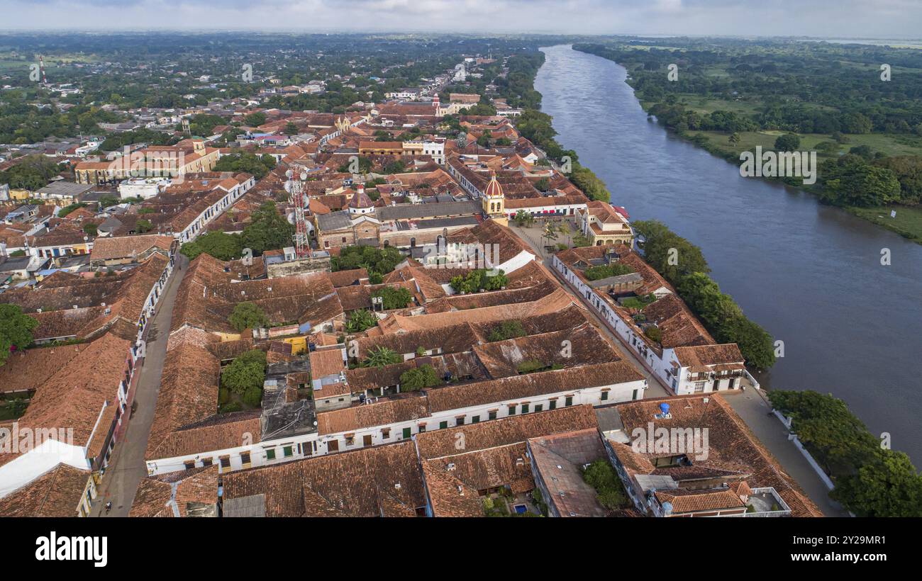 Aerial view of the historic town Santa Cruz de Mompox in sunlight with river and green ...