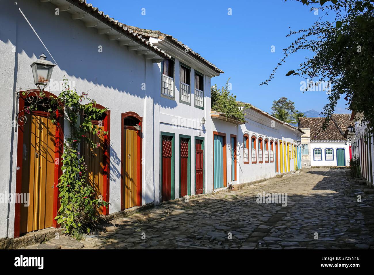 Typical cobblestone street with colorful colonial buildings in the late ...