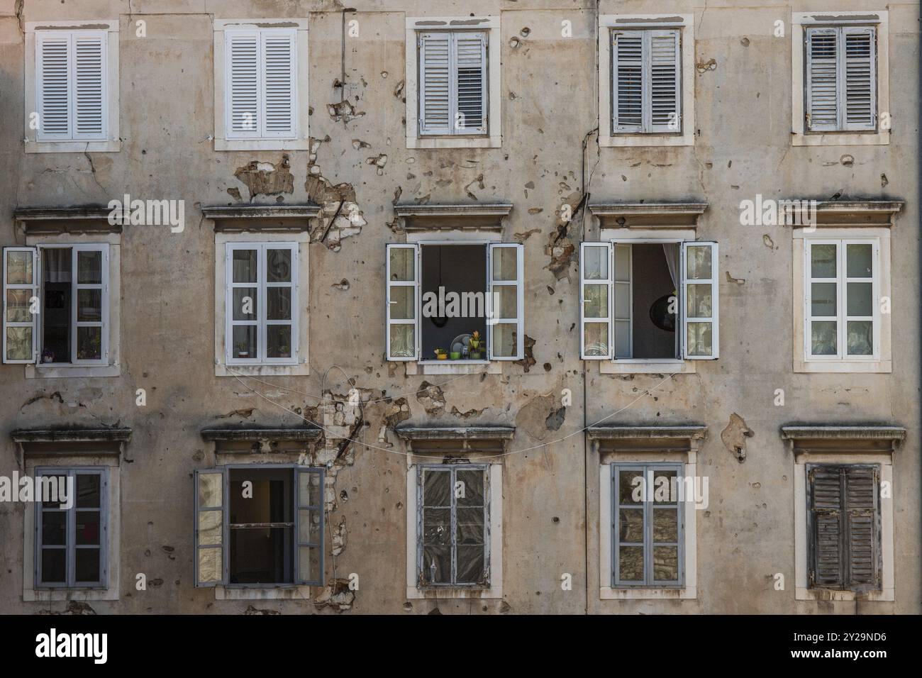 Window of an old building with bullet holes from the Balkan War. Window ...
