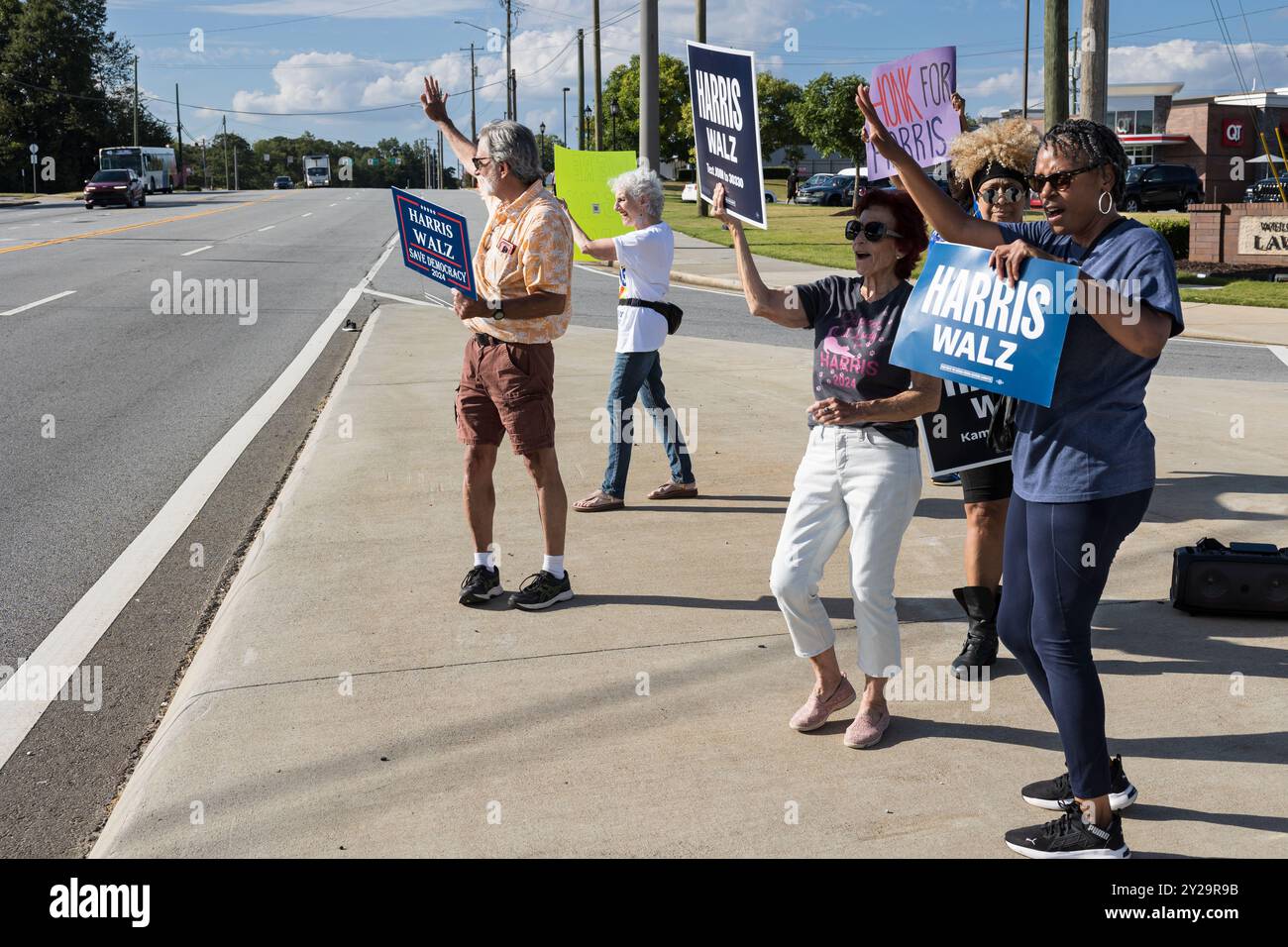 Lawrenceville, GA / USA - September 5, 2024: People hold campaign signs ...