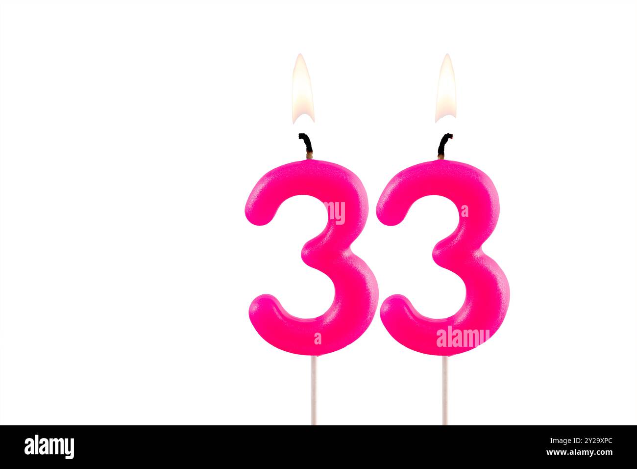 Pink number 33 birthday candle on white background Stock Photo - Alamy