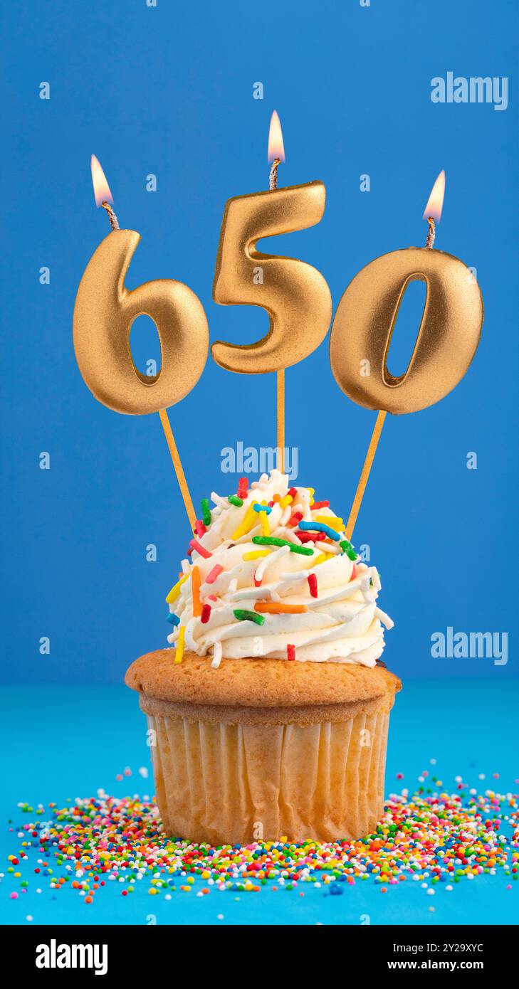 Birthday cupcake with candle number 650 - Blue background Stock Photo ...
