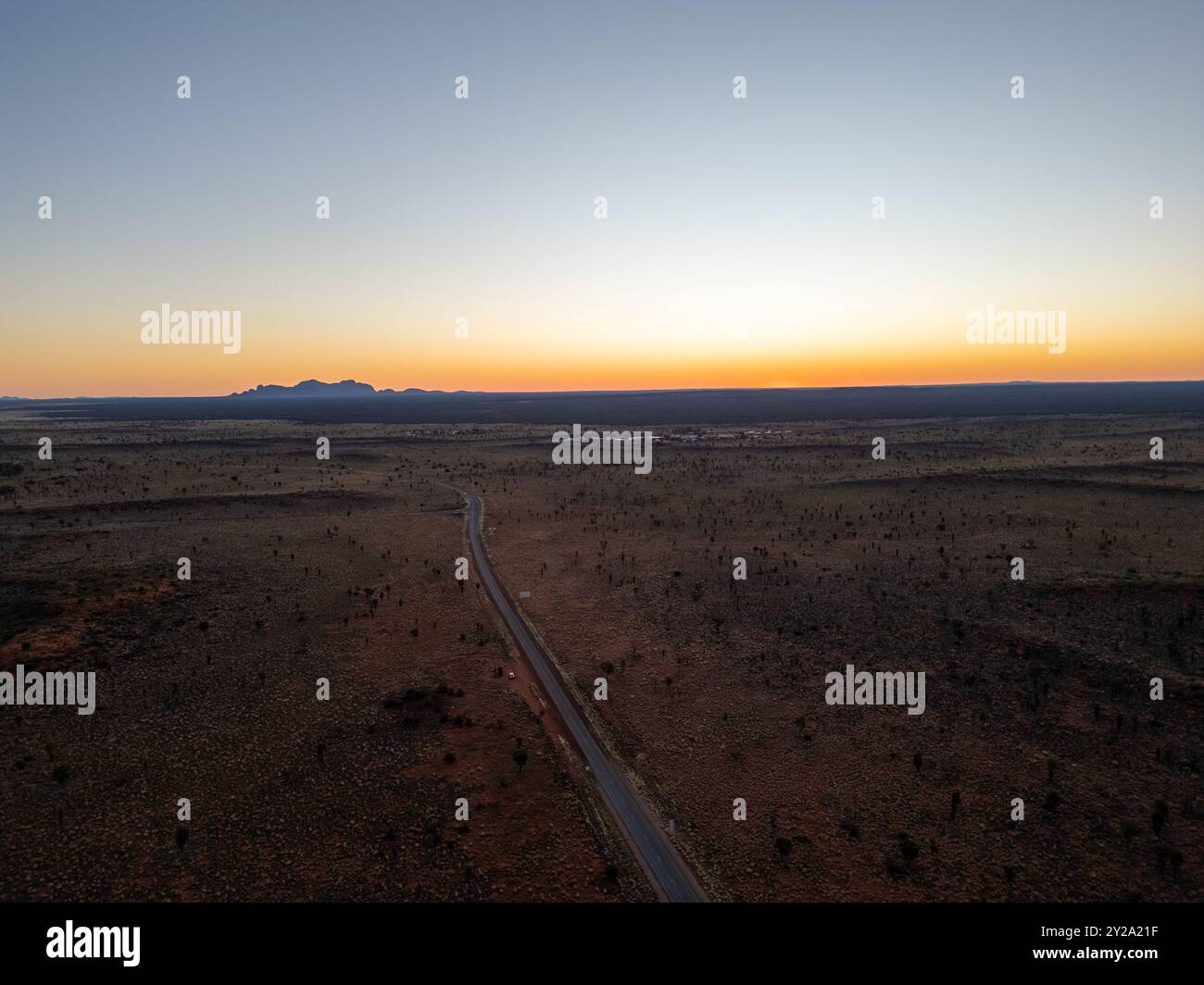 A breathtaking aerial view of Uluru Rock in Australia illuminated by a ...