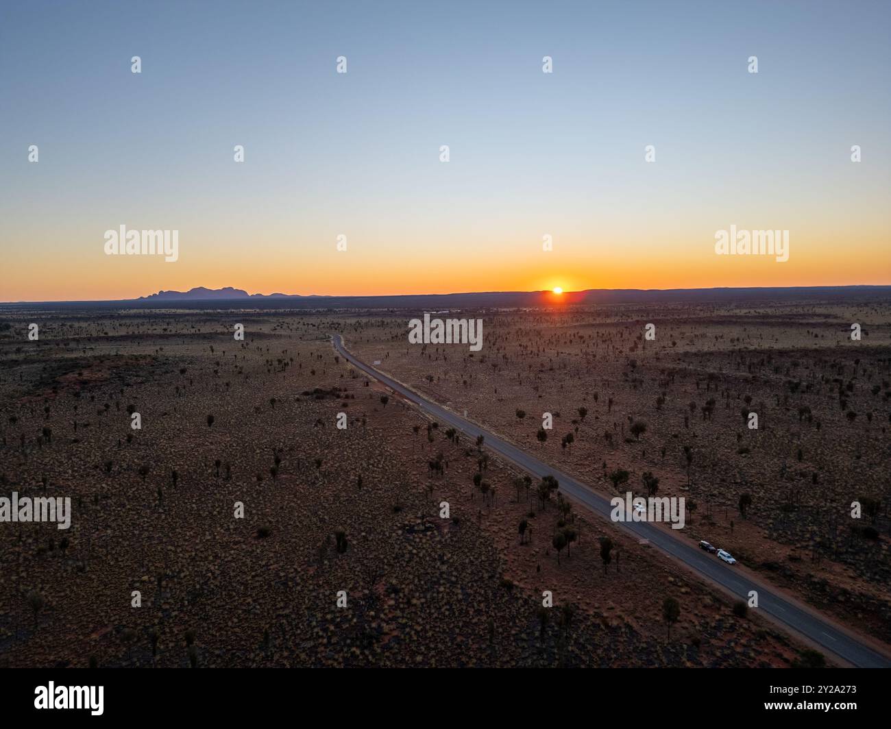 A breathtaking aerial view of Uluru Rock in Australia illuminated by a ...