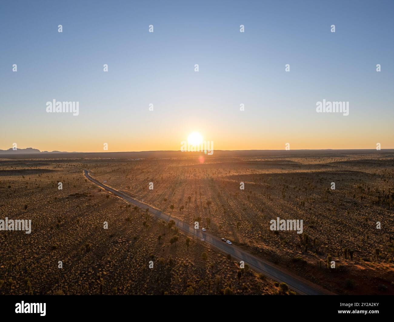 A breathtaking aerial view of Uluru Rock in Australia illuminated by a ...