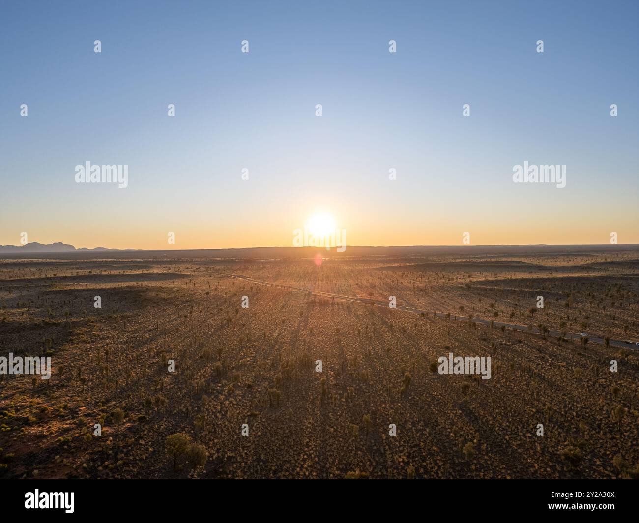 A breathtaking aerial view of Uluru Rock in Australia illuminated by a ...