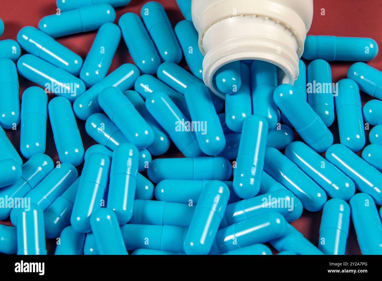 blue medicine capsules and white bottle symbolizing medicine Stock ...