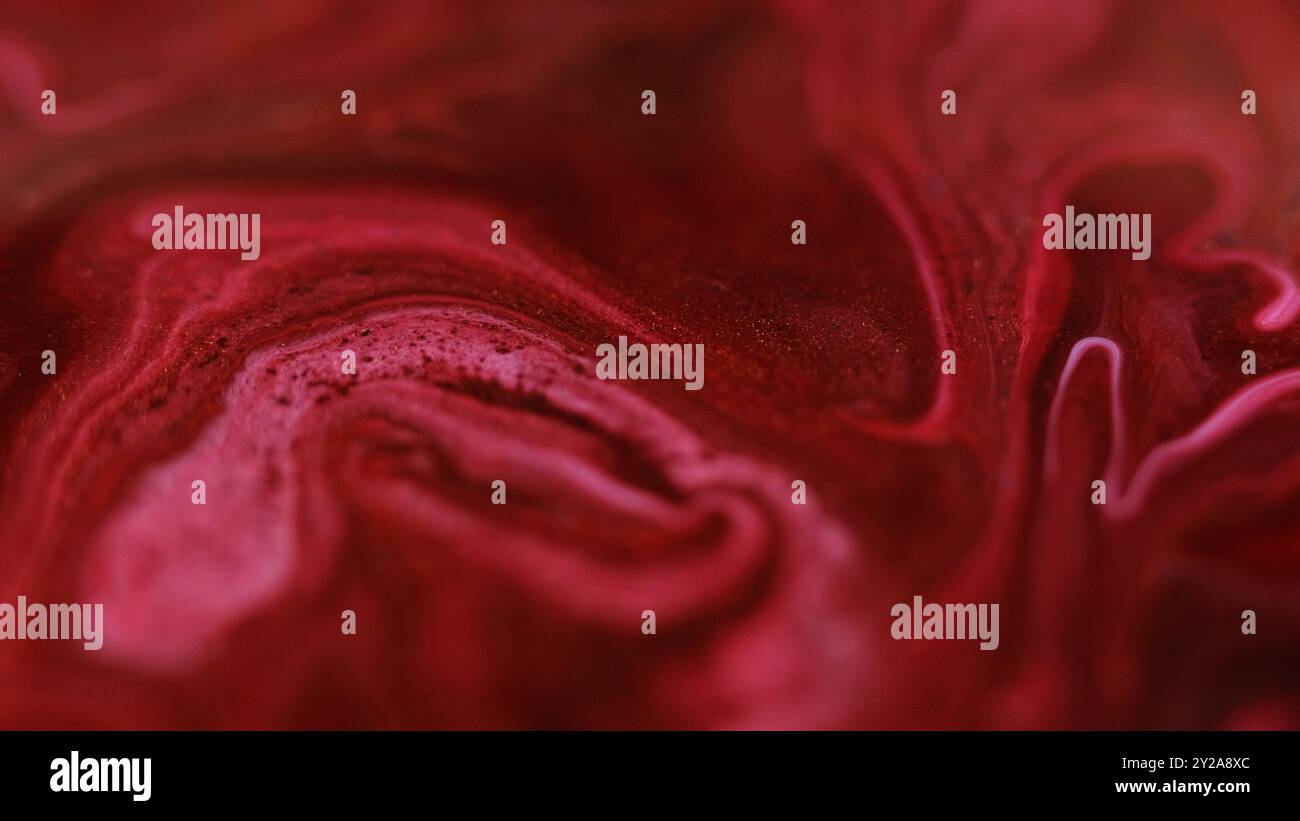 Glitter fluid mix. Paint spill. Defocused red pink color shimmering particles liquid emulsion ...