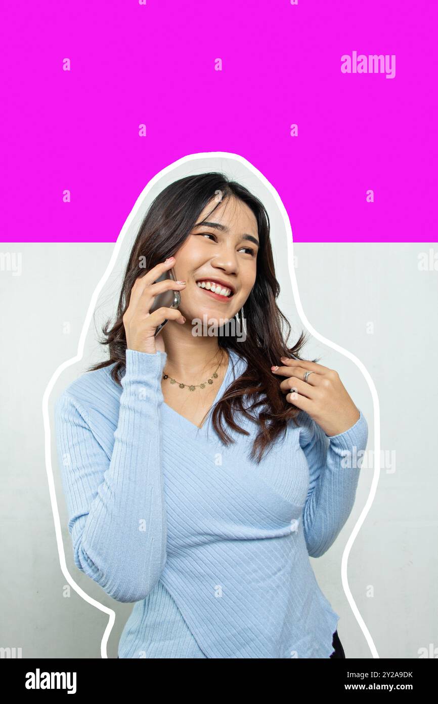 portrait of beautiful asian girl talking on her mobile phone with ...