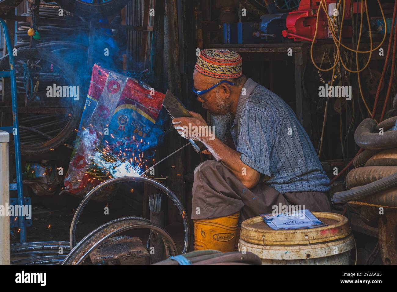 Balikpapan, Indonesia - June 26th, 2024. the the old welder is doing ...