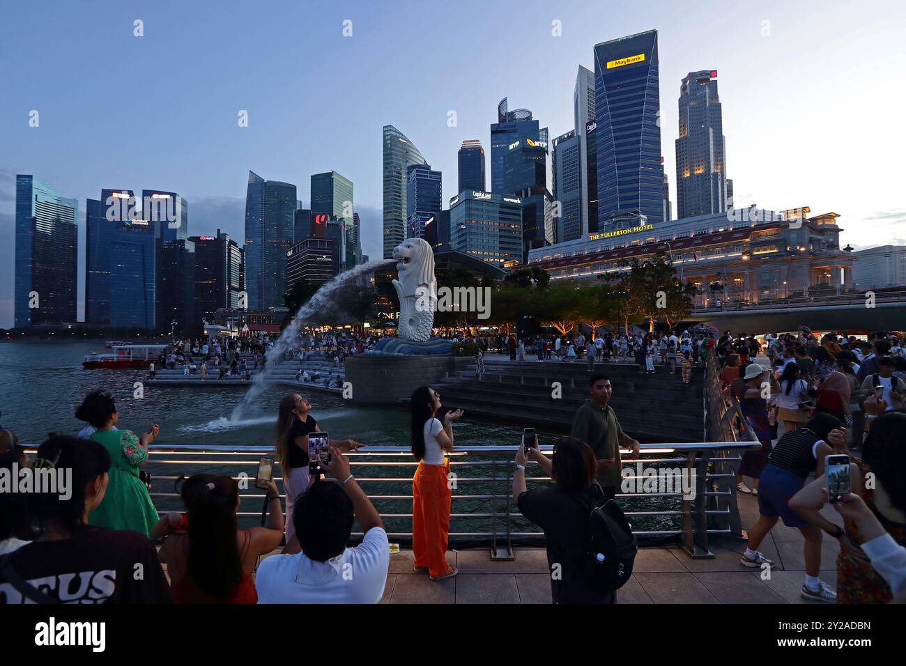 People take photos at Merlion Park in Singapore, Saturday, Sept. 7 ...