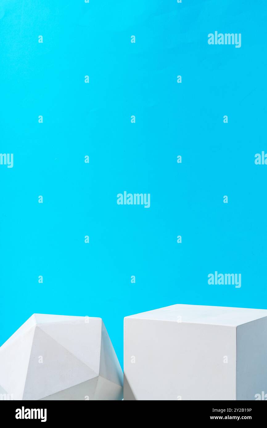 Two geometric shapes on display against a bright blue background in a ...