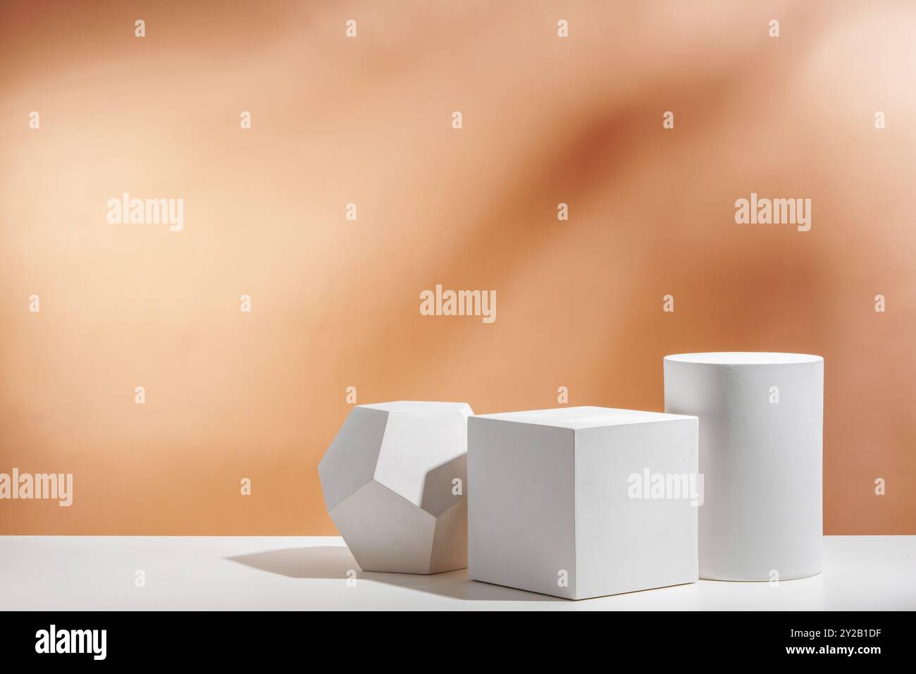 White geometric shapes arranged stylishly on a soft peach background in ...