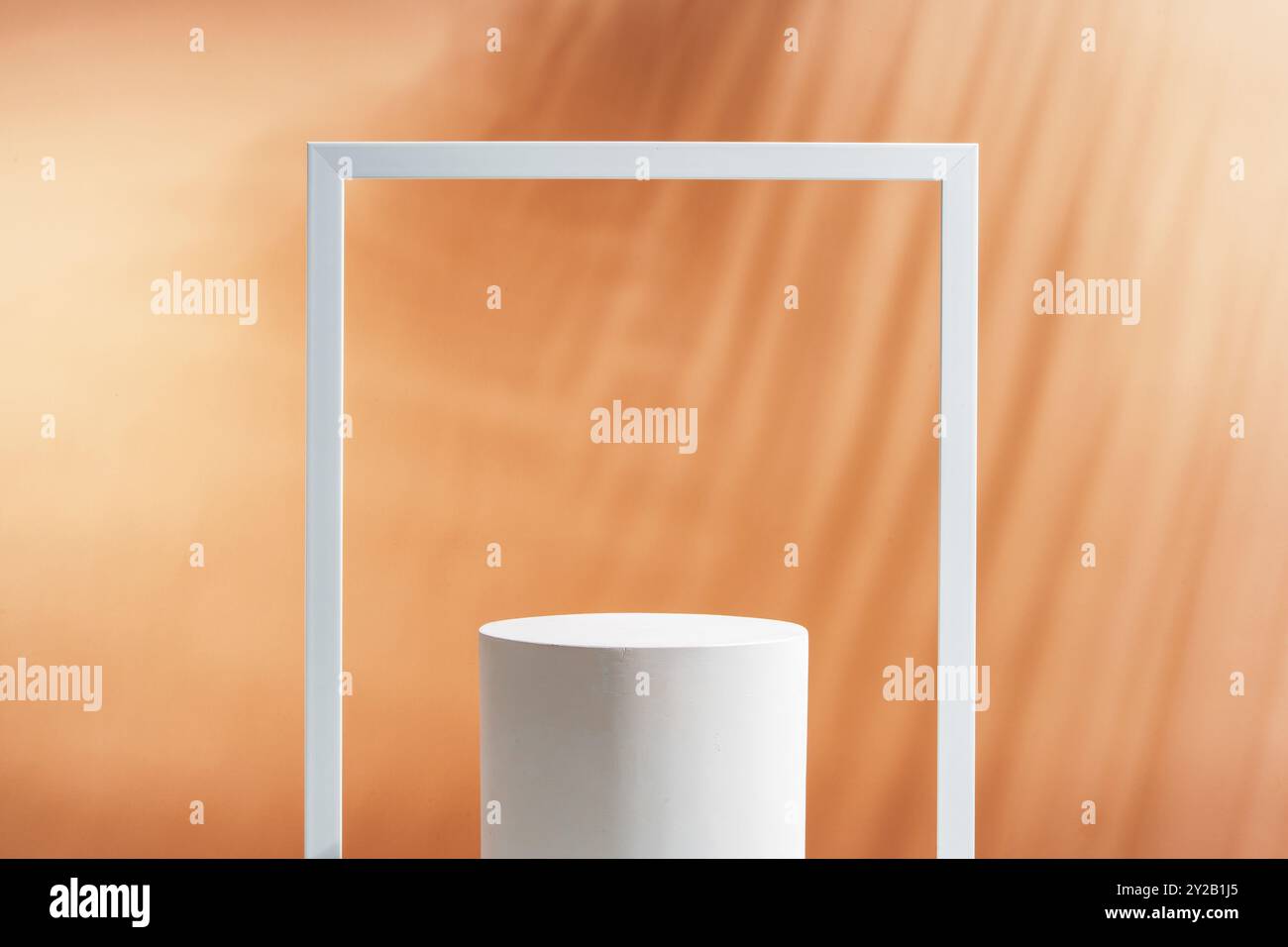 Minimalistic display of a white cylindrical object framed by a white ...