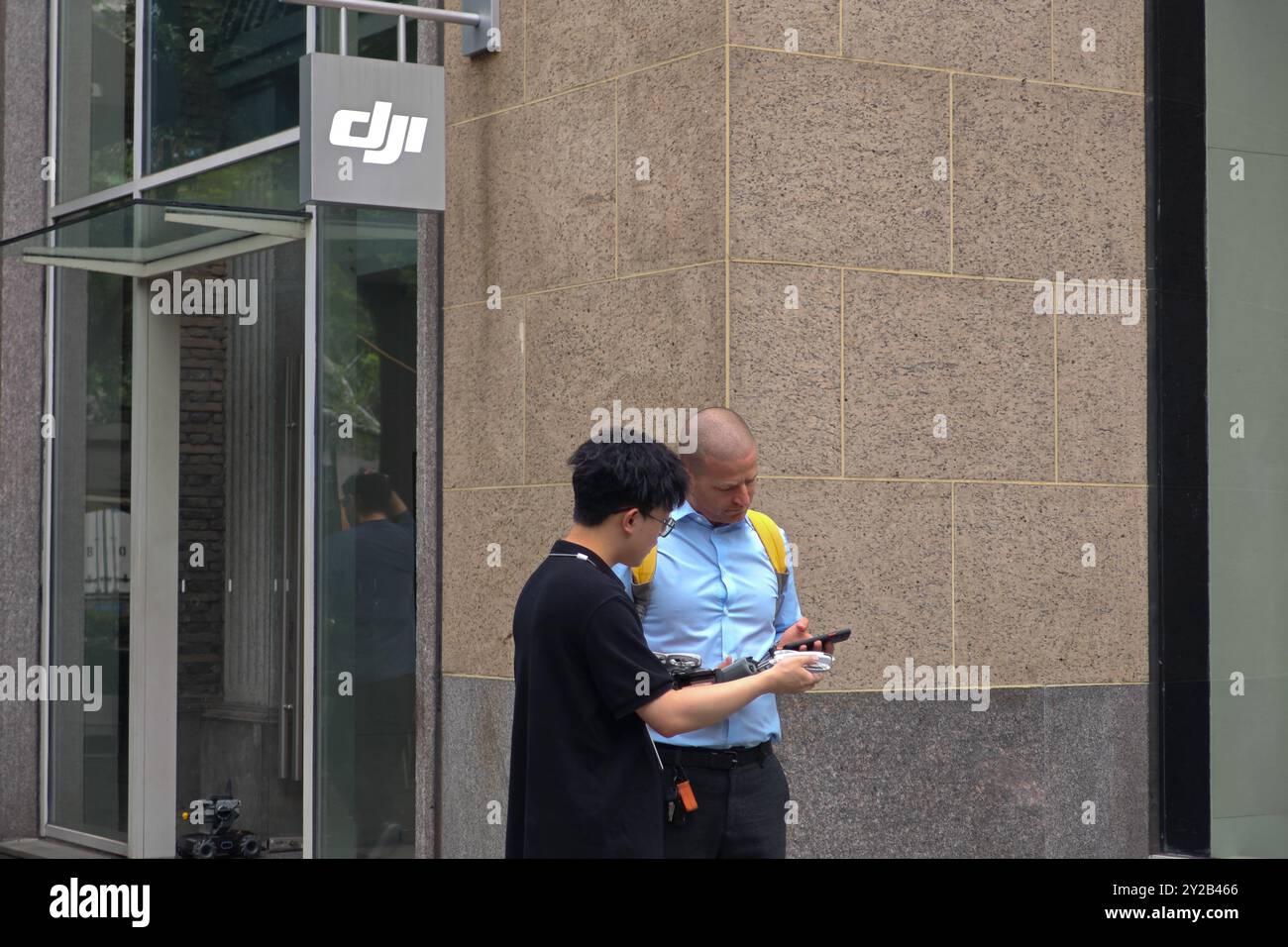 SHANGHAI, CHINA - SEPTEMBER 10, 2024 - Pedestrians walk past the flagship store of DJI in ...