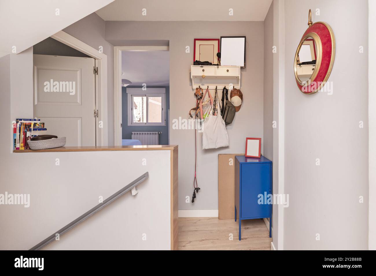 Hallway of a house with grey painted walls and wooden floor and access ...