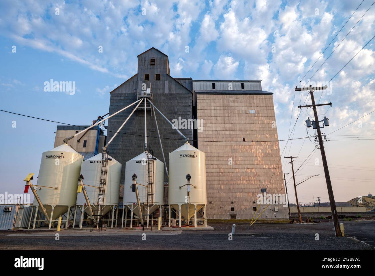 Modern storage bins in front of an old grain elevator at the town of ...